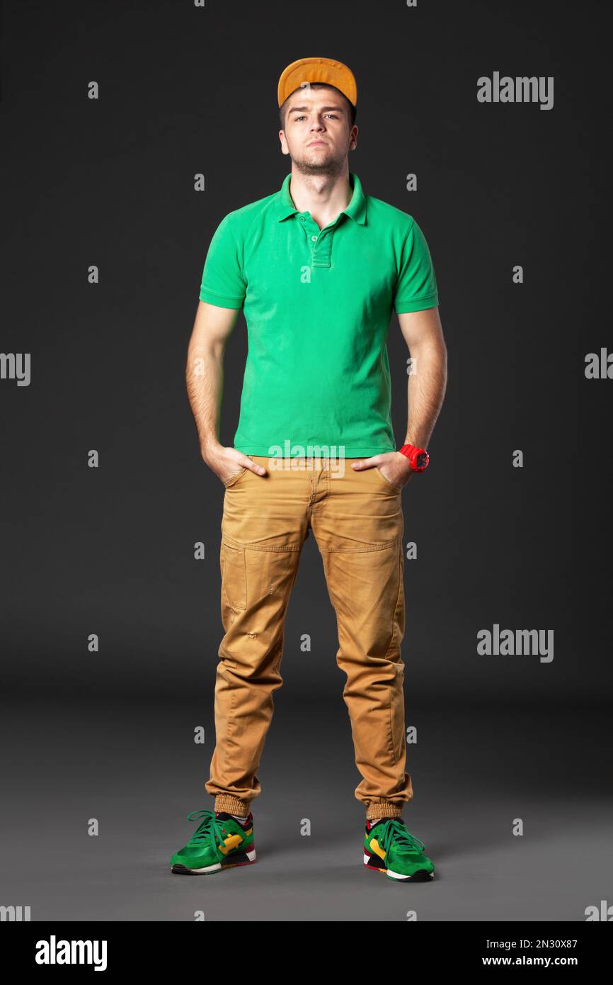 Full body portrait of confident young man posing in studio isolated on ...