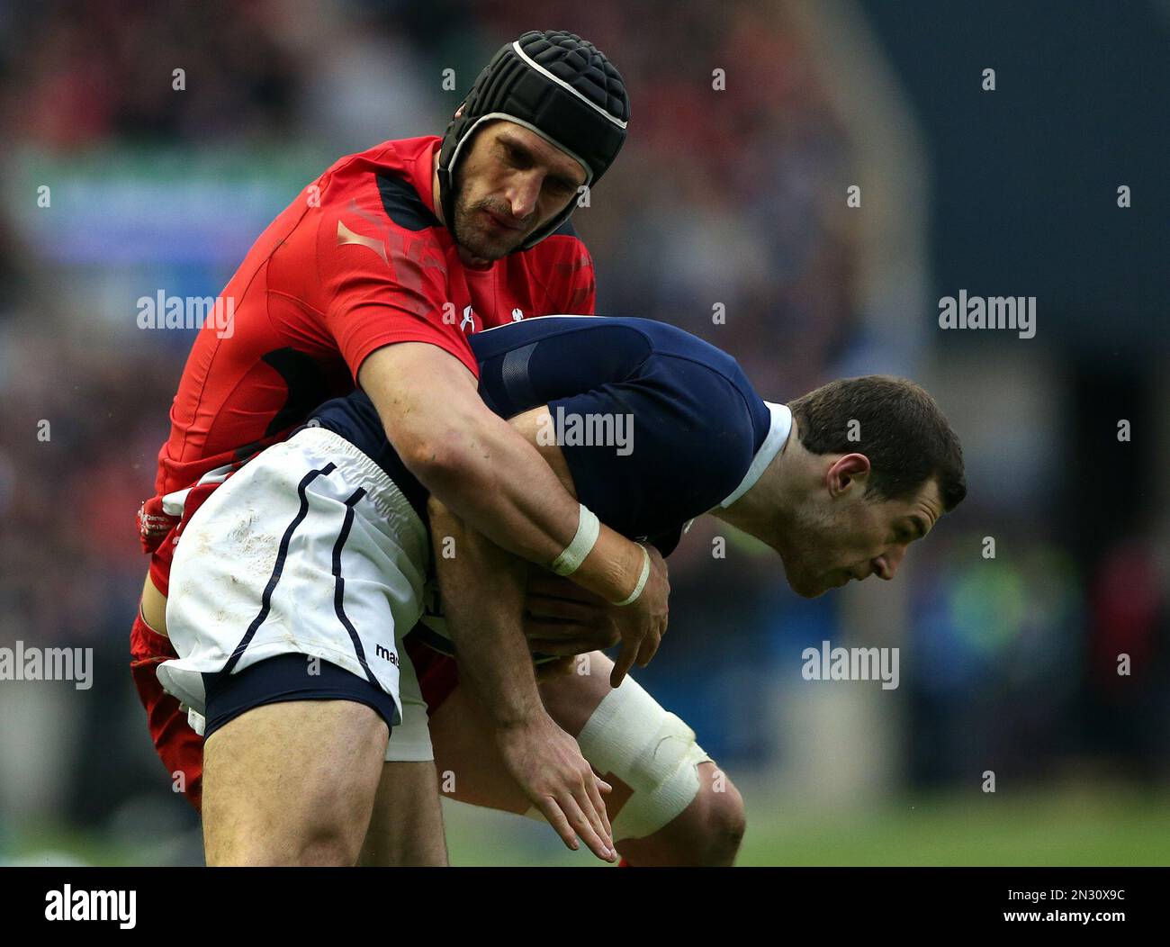 Scotland's Tim Visser, right, is tackled by Wales' Luke Charteris, left ...