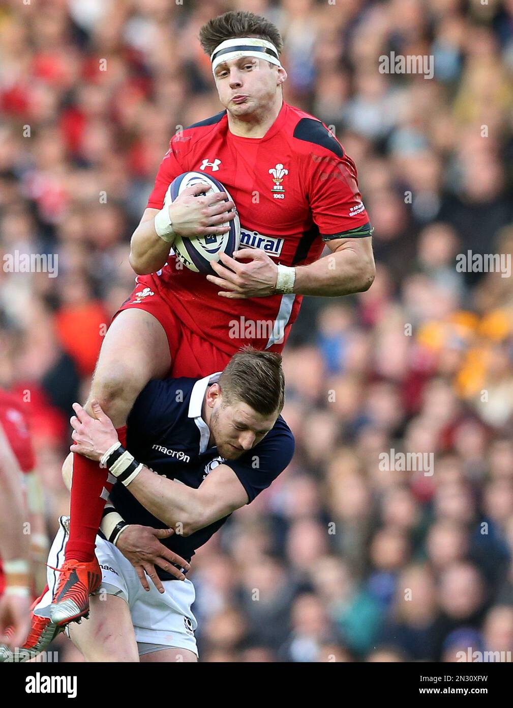 Wales' Dan Biggar, left, is tackled by Scotland's Finn Russell, right ...