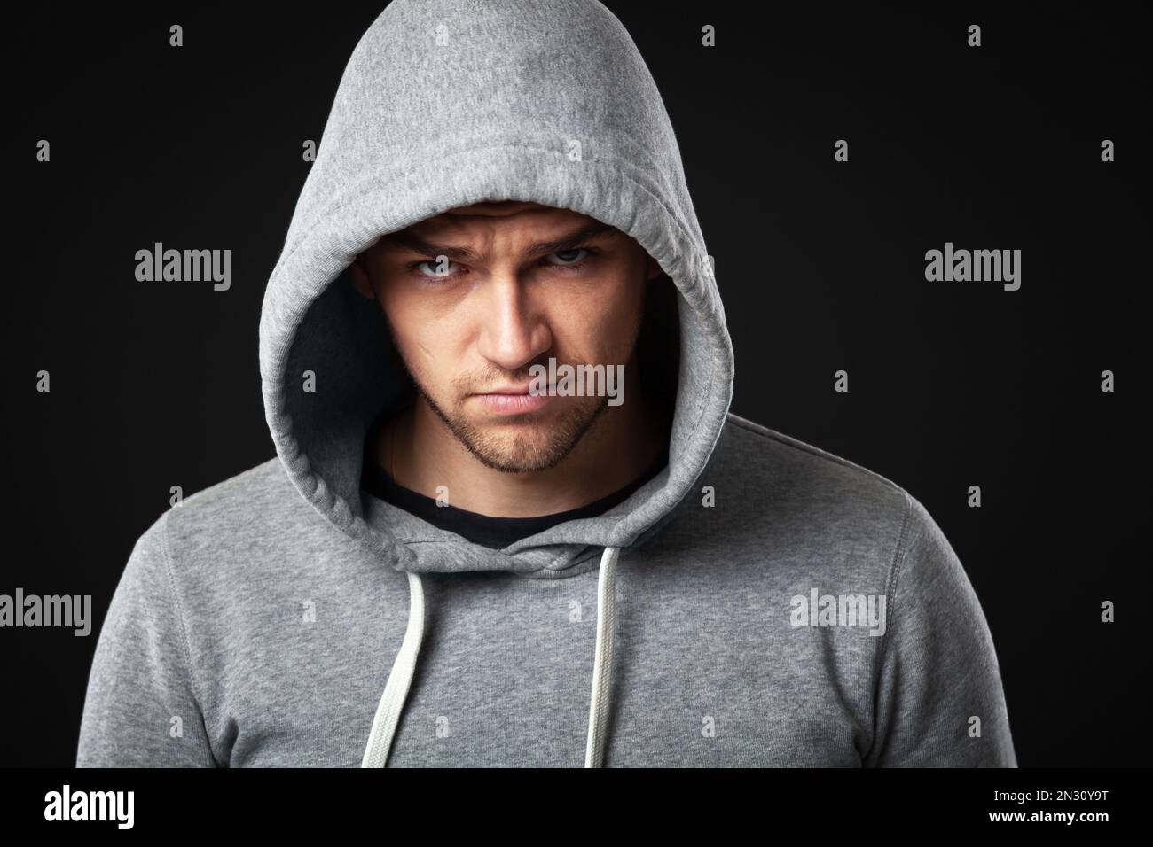 Studio portrait of cool looking young guy in sportswear standing ...