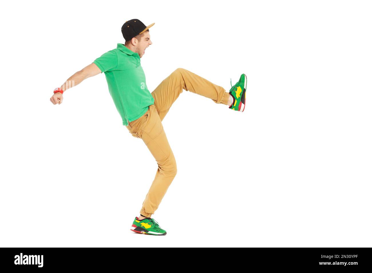 Fullbody portrait of young male kicking in studio isolated on white ...