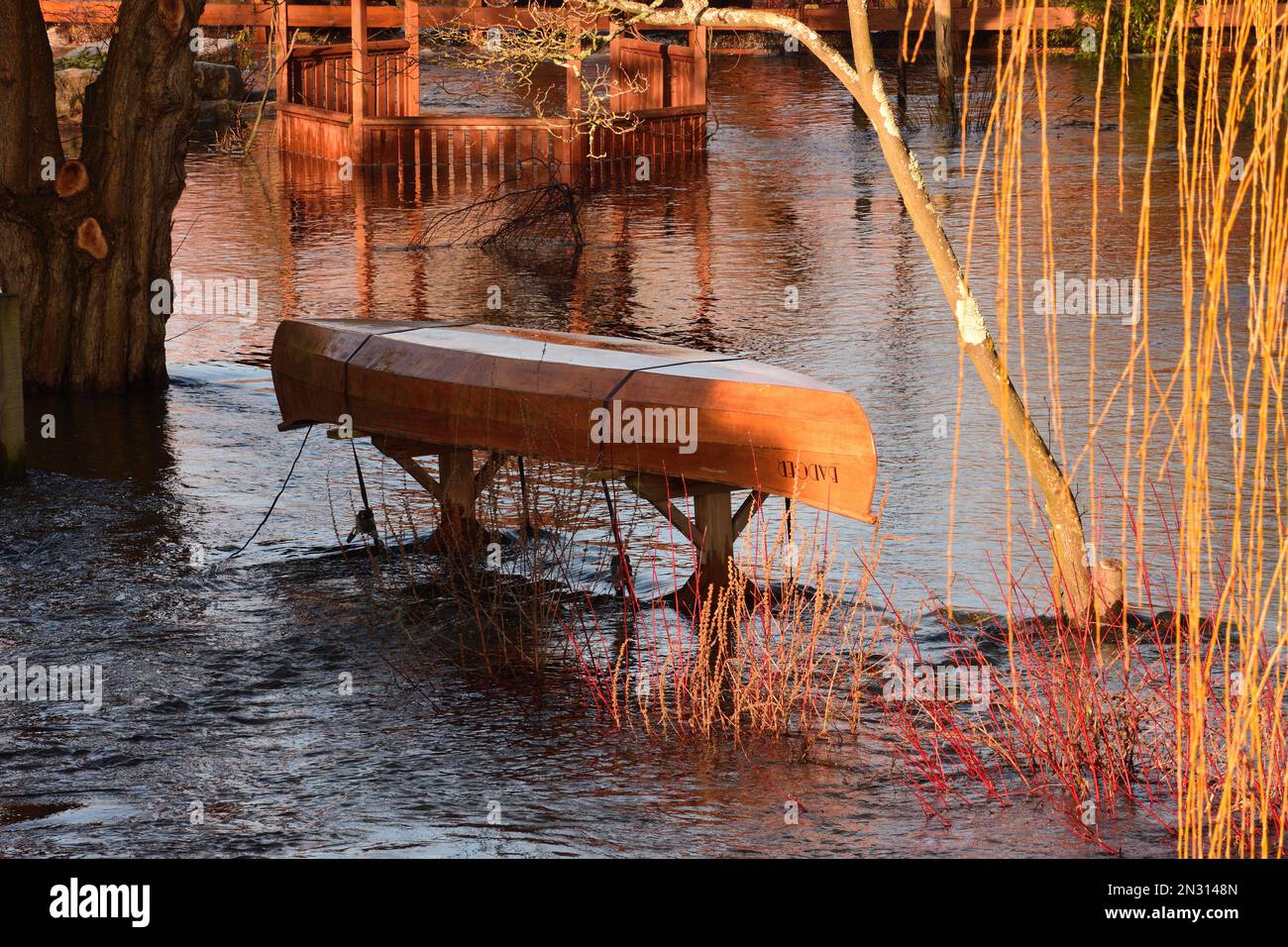 Upturned canoe in flooded garden Stock Photo - Alamy