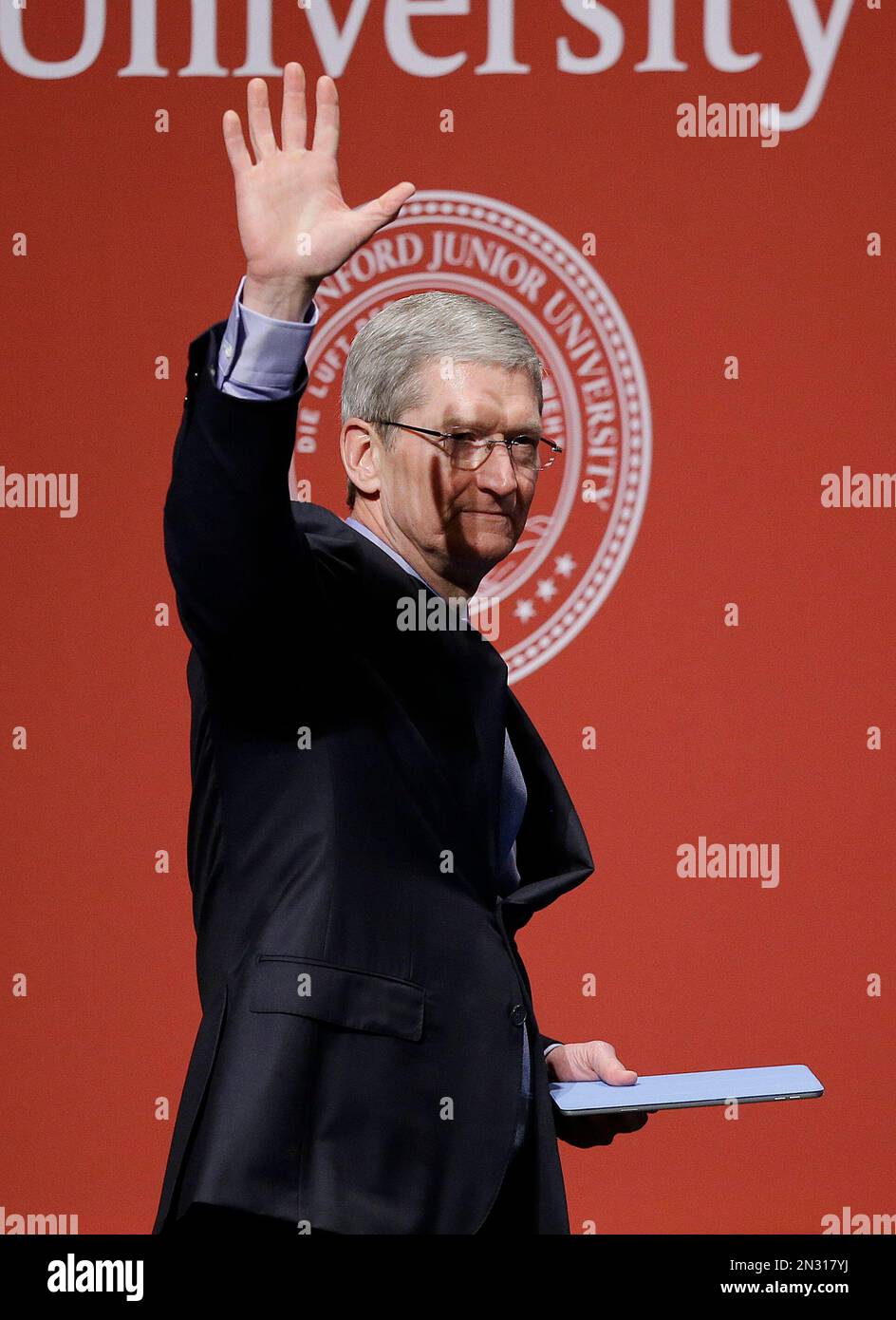 Apple CEO Tim Cook waves before speaking at the White House Summit on ...