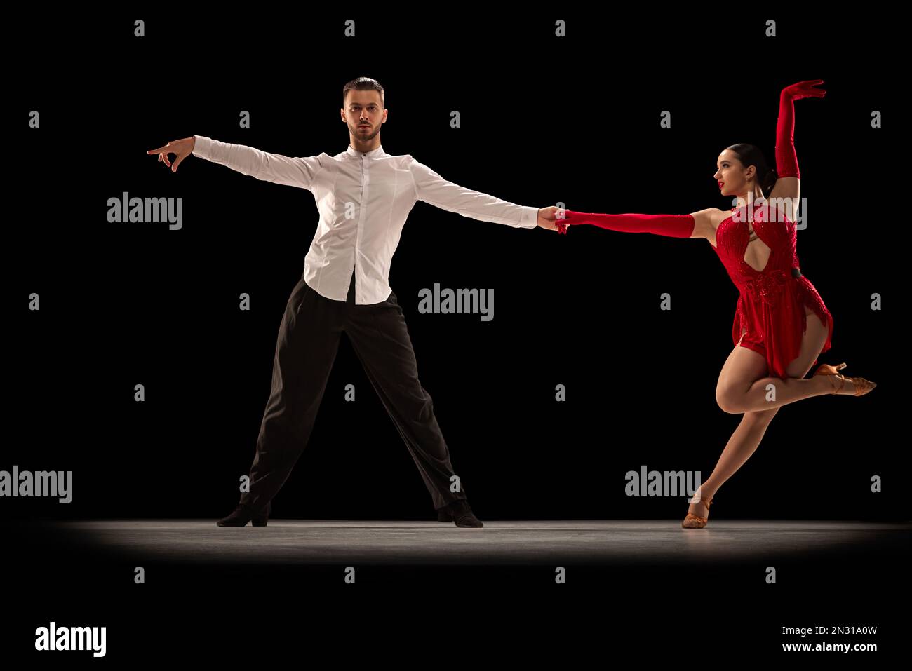 Professional dancers. Art. Young man and woman in stylish stage costumes dancing tango, ballroom ...