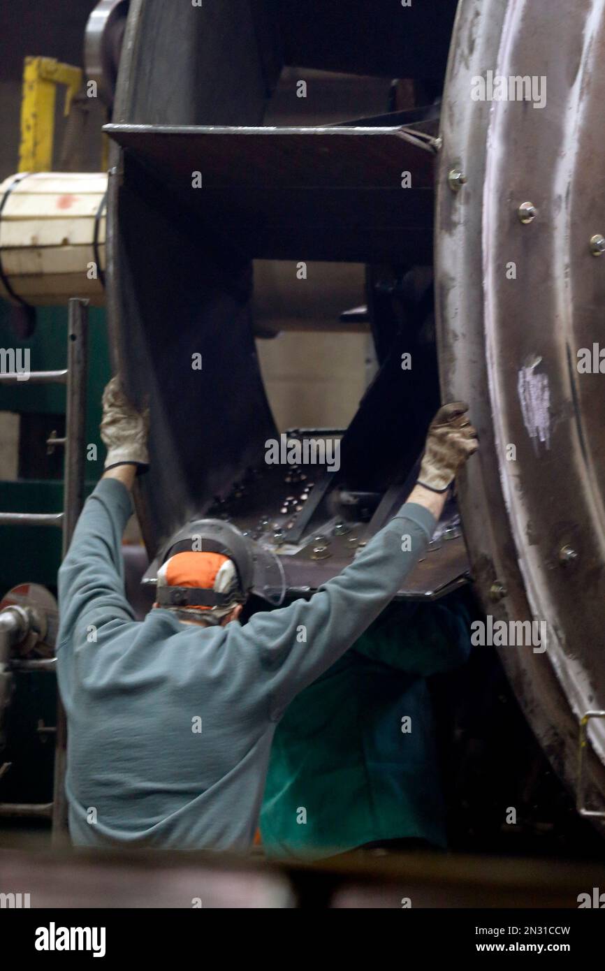In this photo made on Thursday, Feb. 12, 2015, a worker builds fans for ...