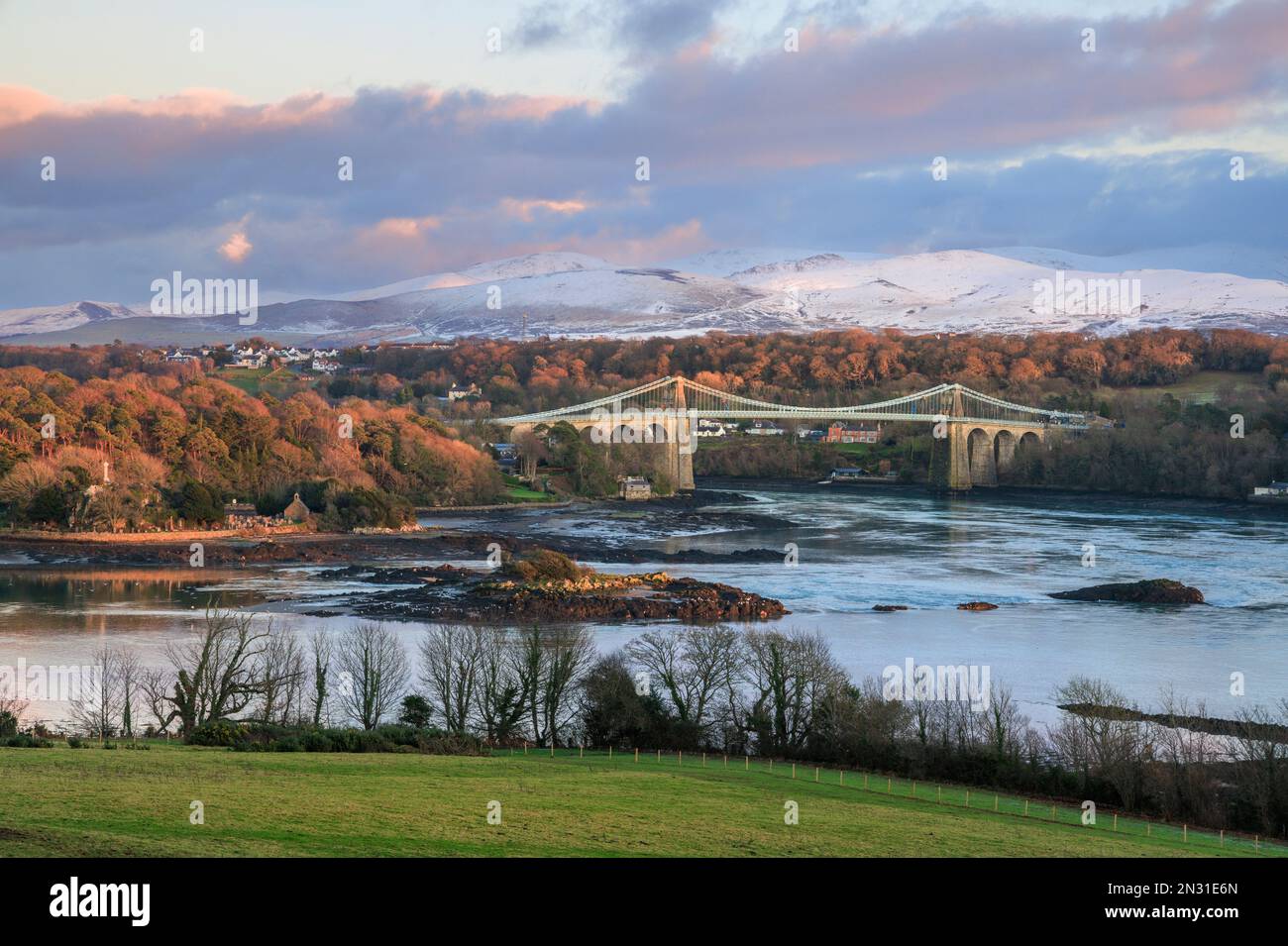 The Telford Bridge over the Menai Strait at sunset with the snow ...