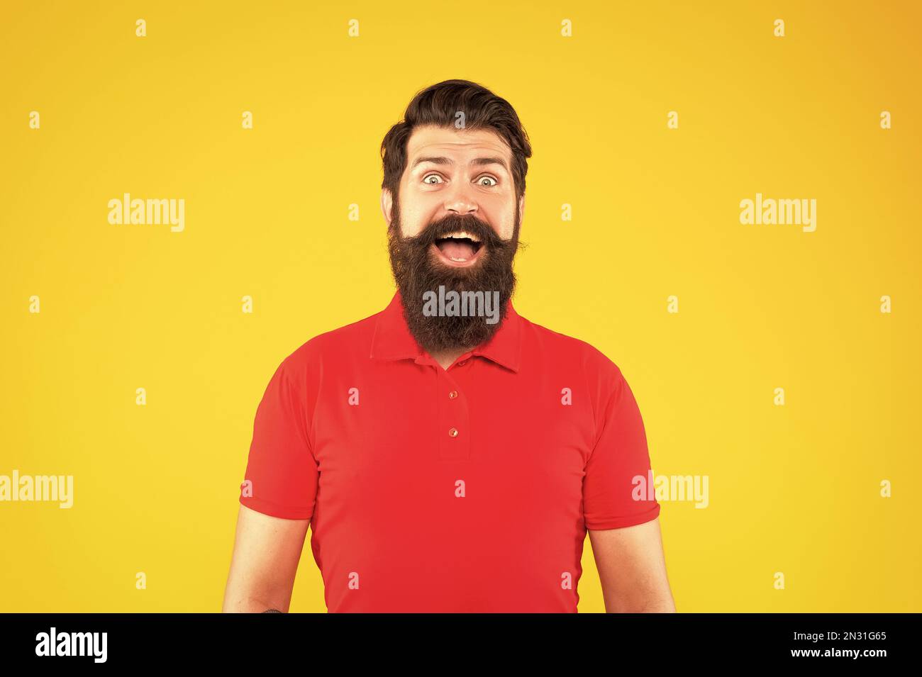 amazed guy with beard and hairstyle on yellow background, face Stock ...