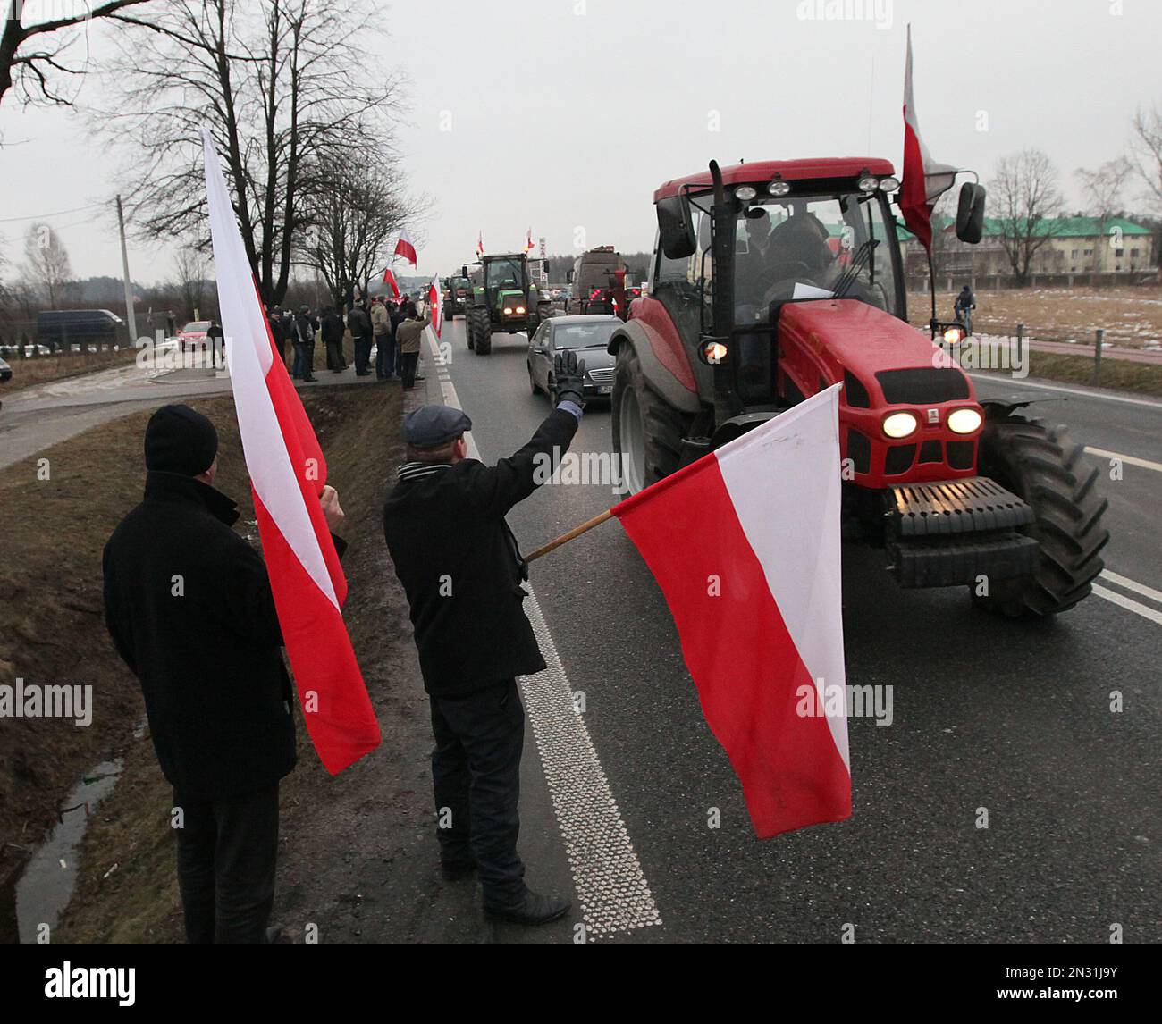 Farmers drive their tractors through Koberne on their way to Warsaw ...