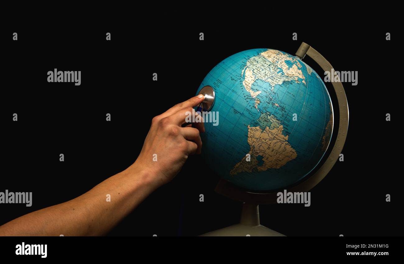 human hand examining the planet earth with a stethoscope Stock Photo ...