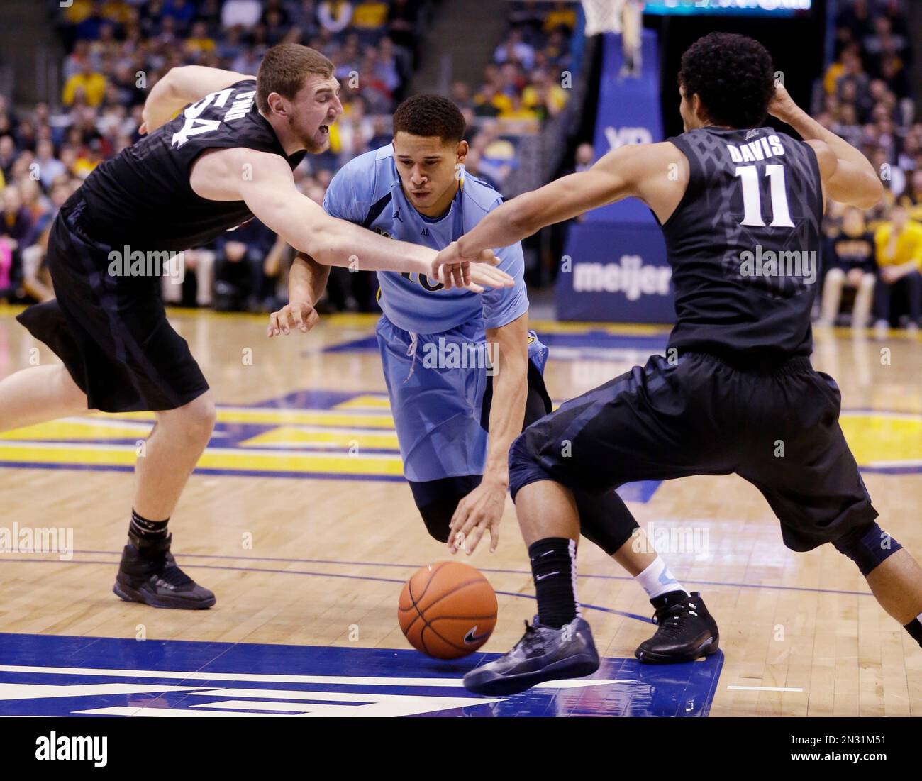 Marquette's Juan Anderson loses the ball as he drives between Xavier's ...