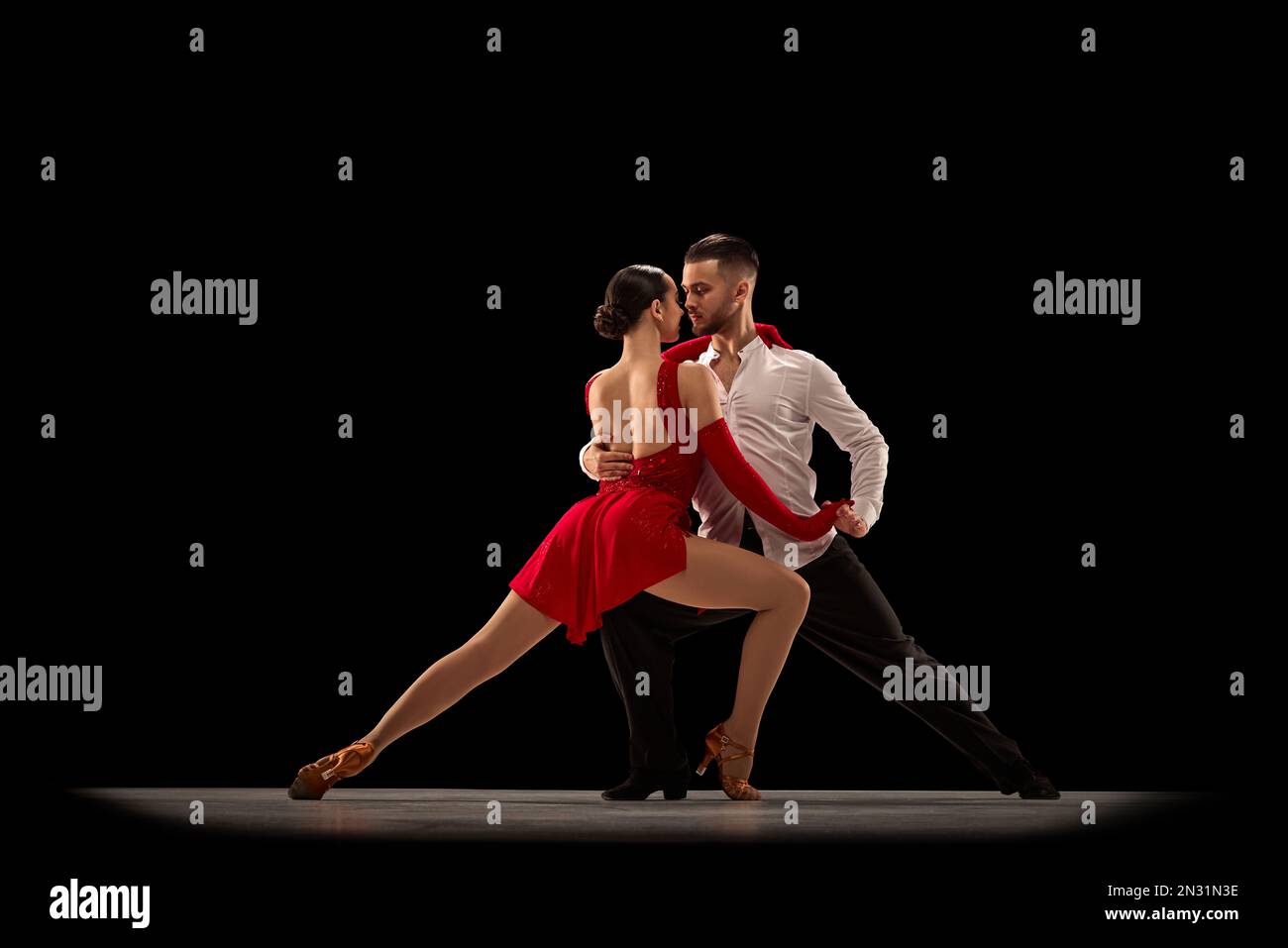 Talented performers. Beautiful young people, man and woman in classical ballroom stage costumes ...