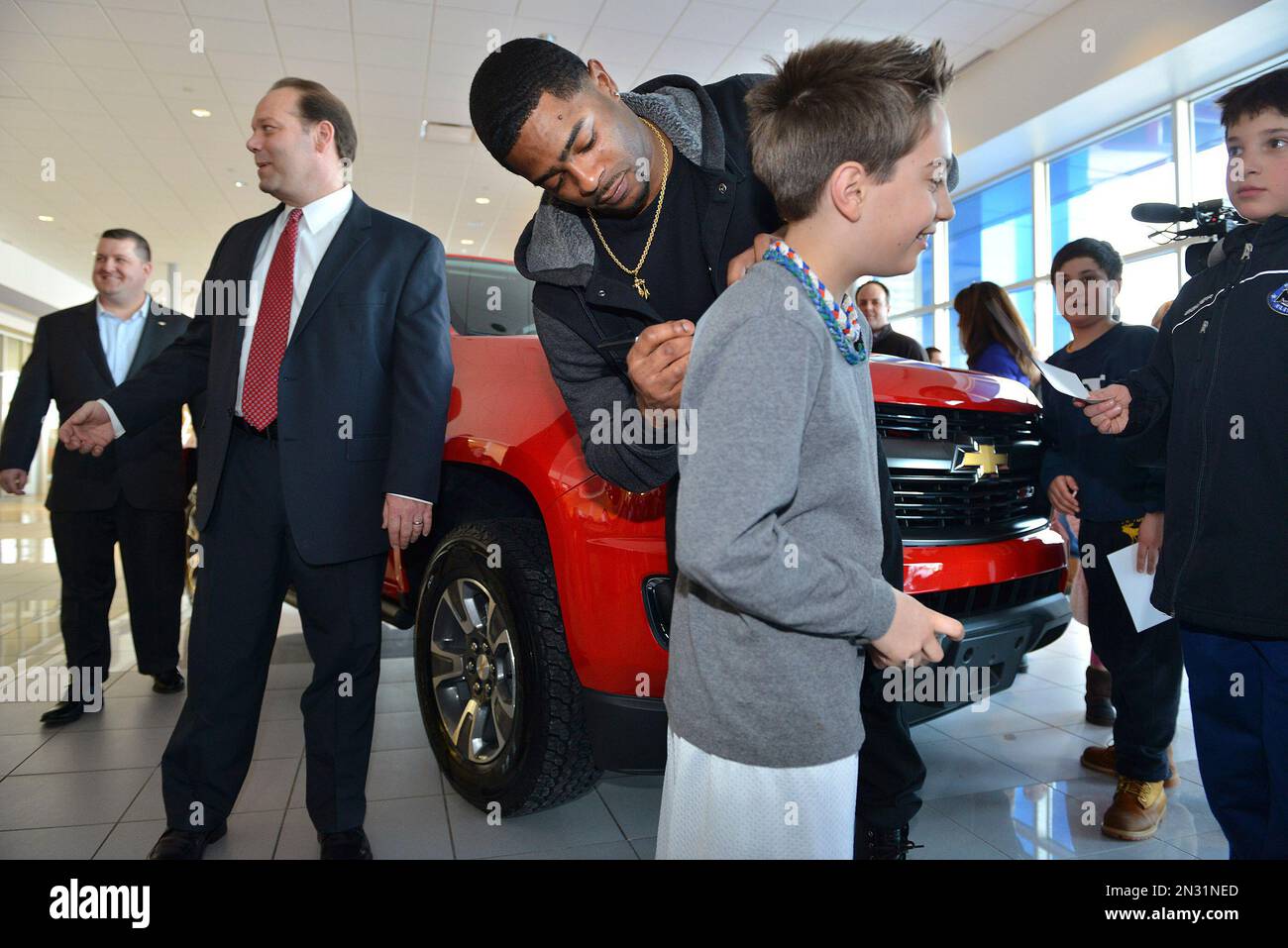 New England Patriots cornerback Malcolm Butler, center, signs an ...
