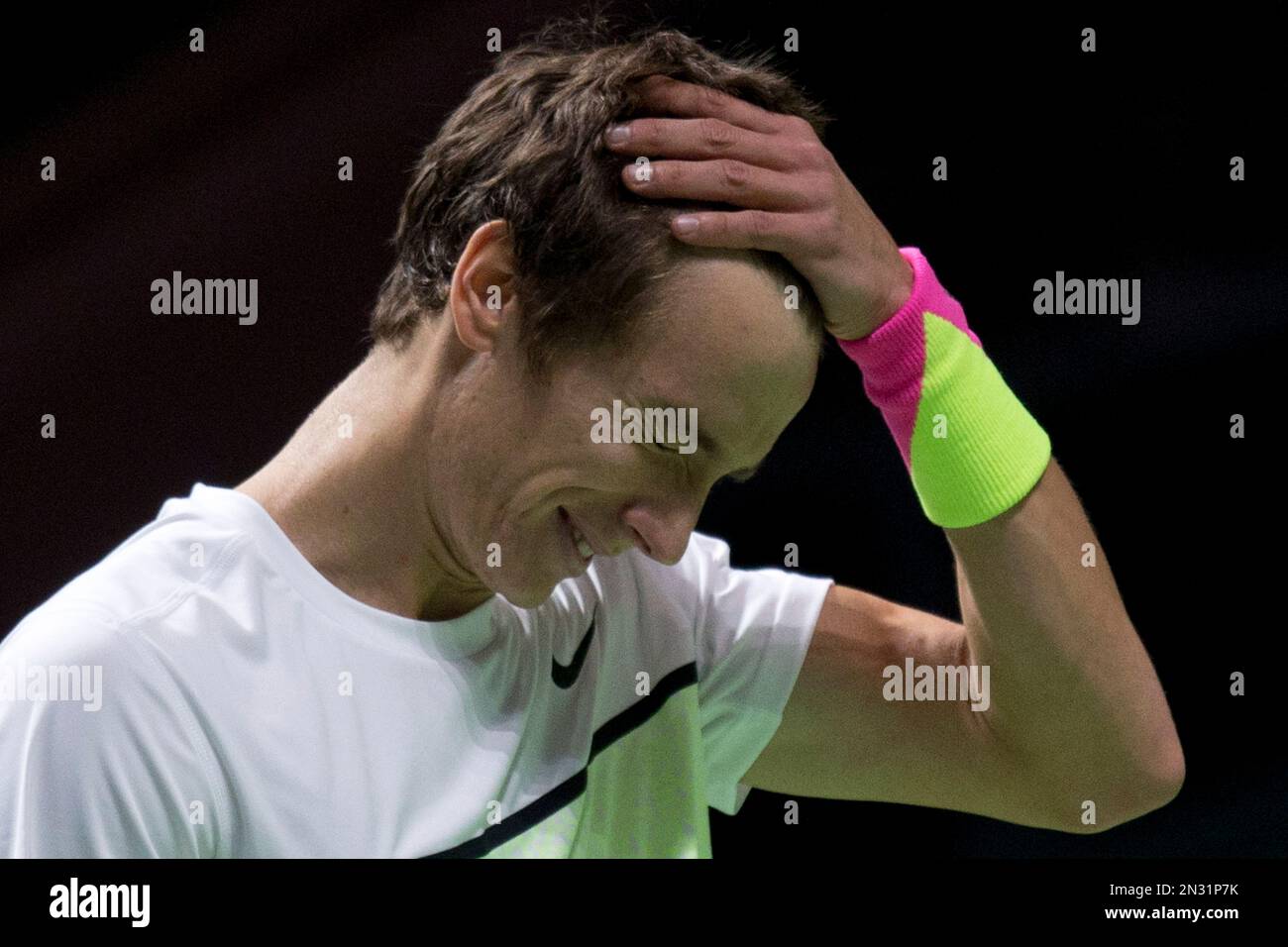 Russia's Andrey Kuznetsov grabs his head after failing to return a shot by Canada's Milos Raonic ...