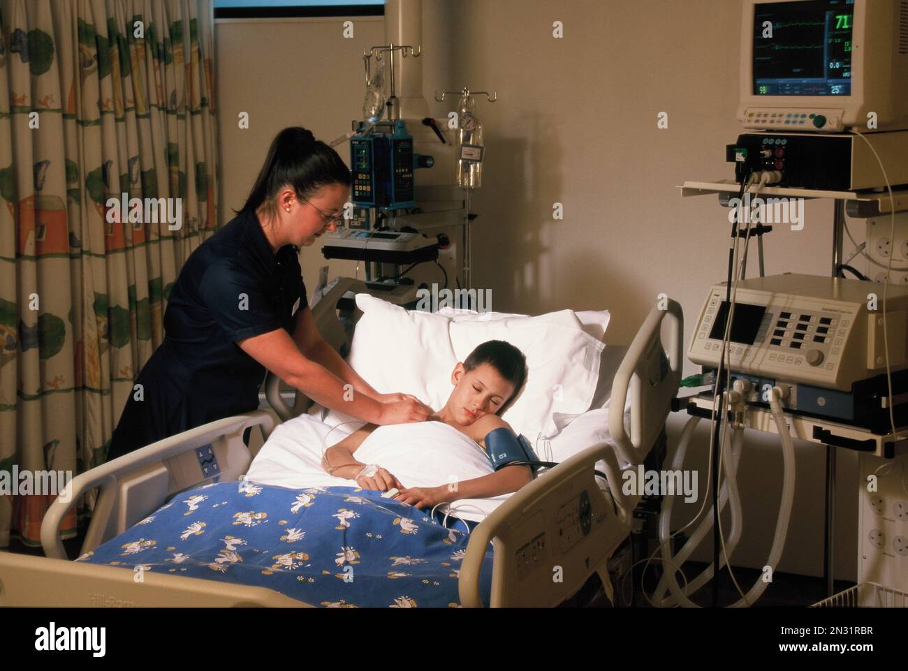 Young boy patient with nurse in hospital intensive care unit Stock ...