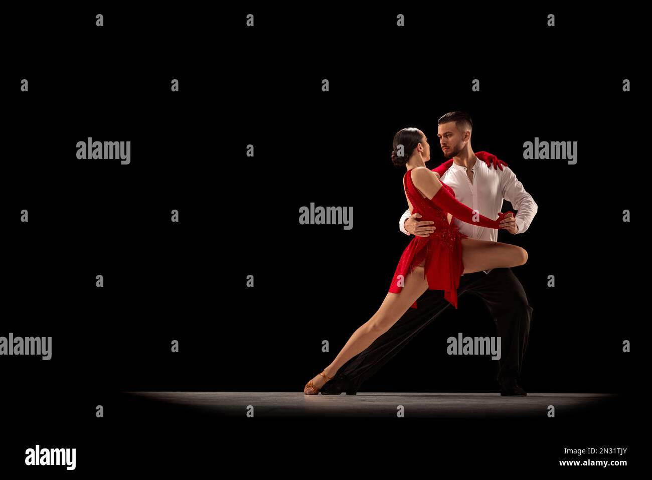 Talented performers. Beautiful young people, man and woman in classical ballroom stage costumes ...