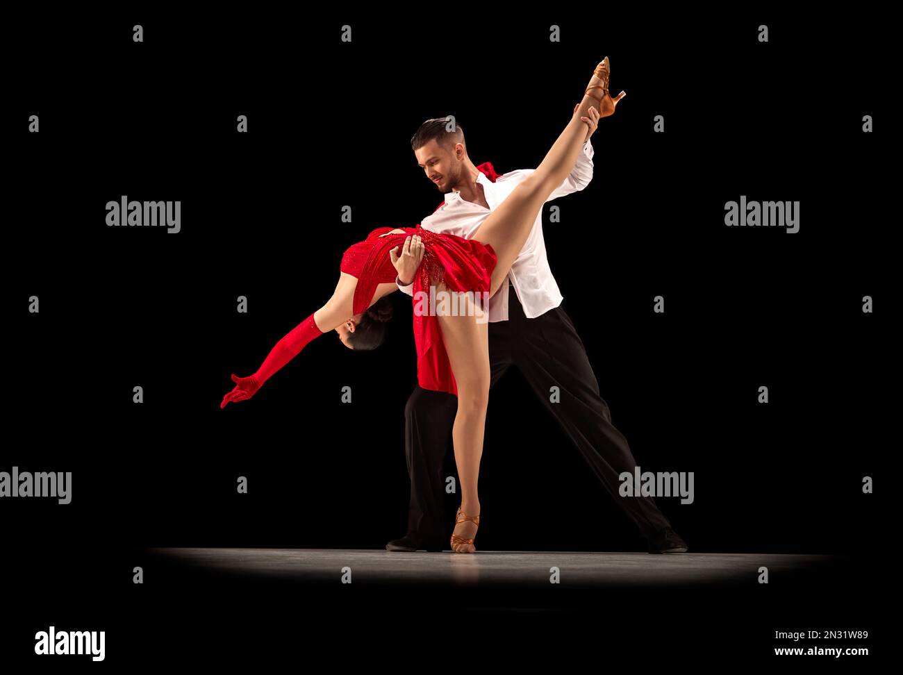 Talented performers. Beautiful young people, man and woman in classical ballroom stage costumes ...