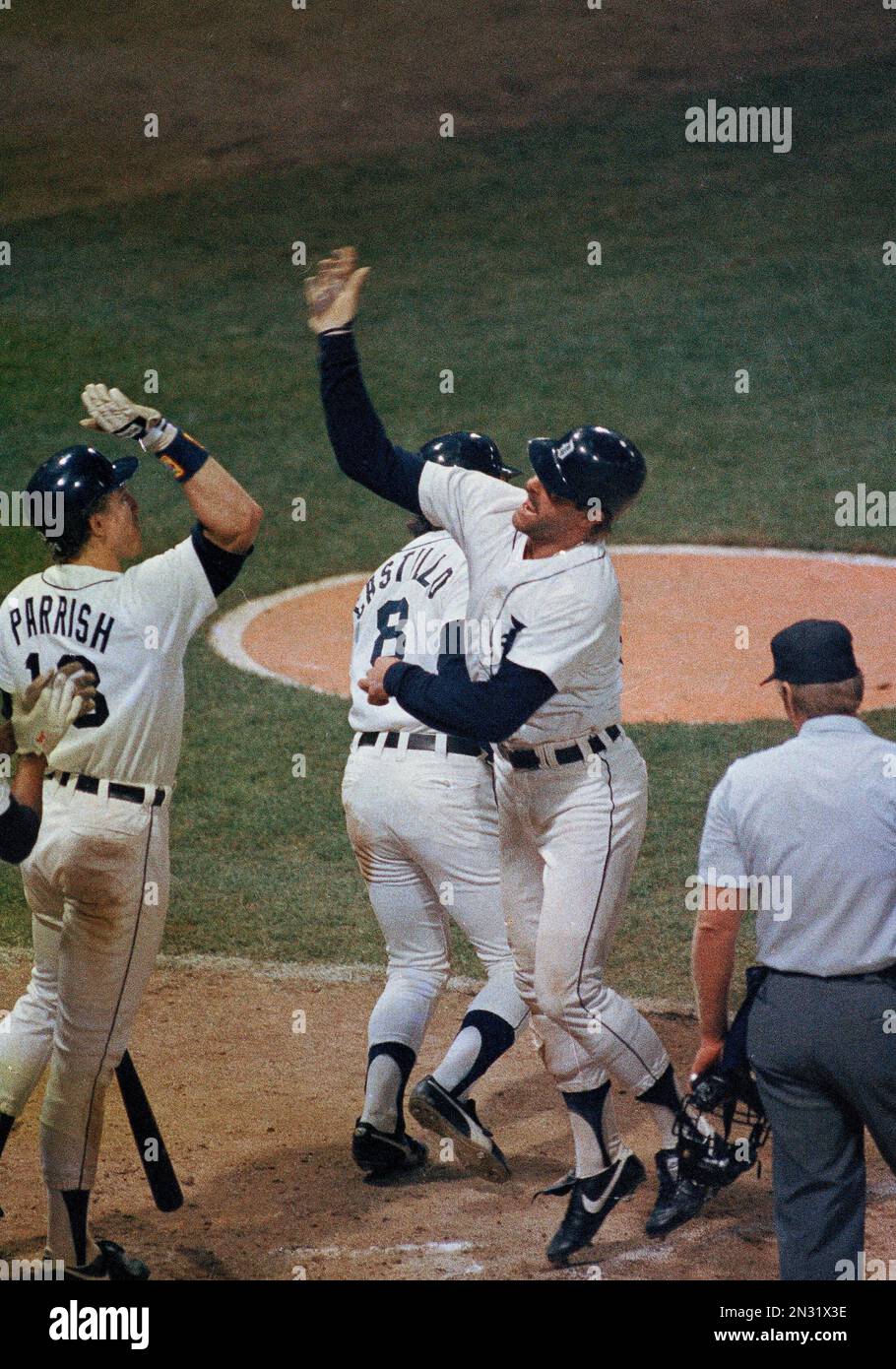 Detroit Tigers Kirk Gibson is greeted at the plate by teammates ...