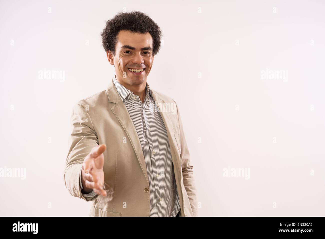 Portrait of happy and successful businessman showing handshake gesture ...