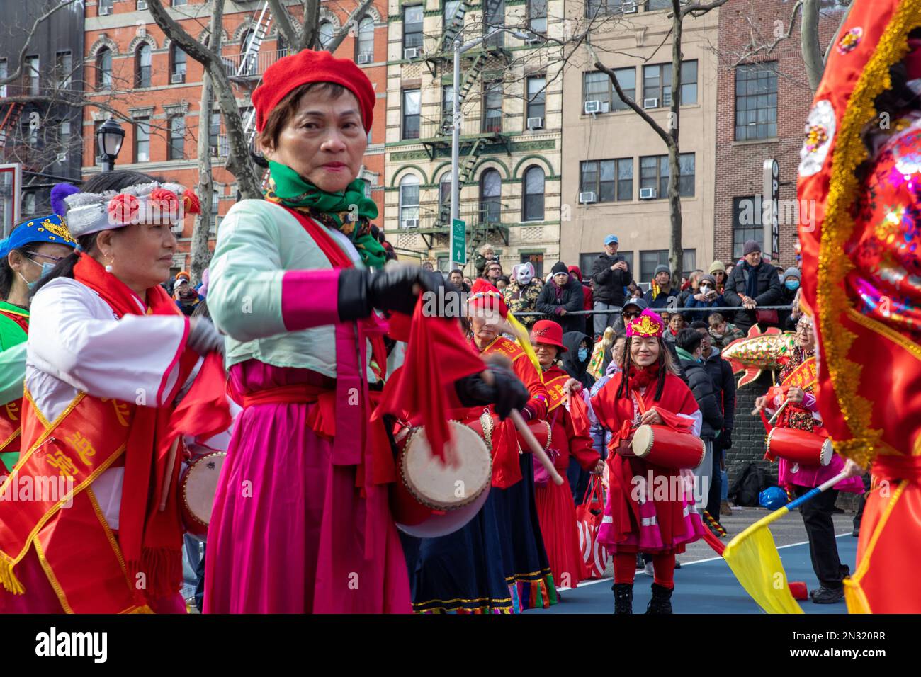 A group of people in colorful costumes in the street during the Chinese ...