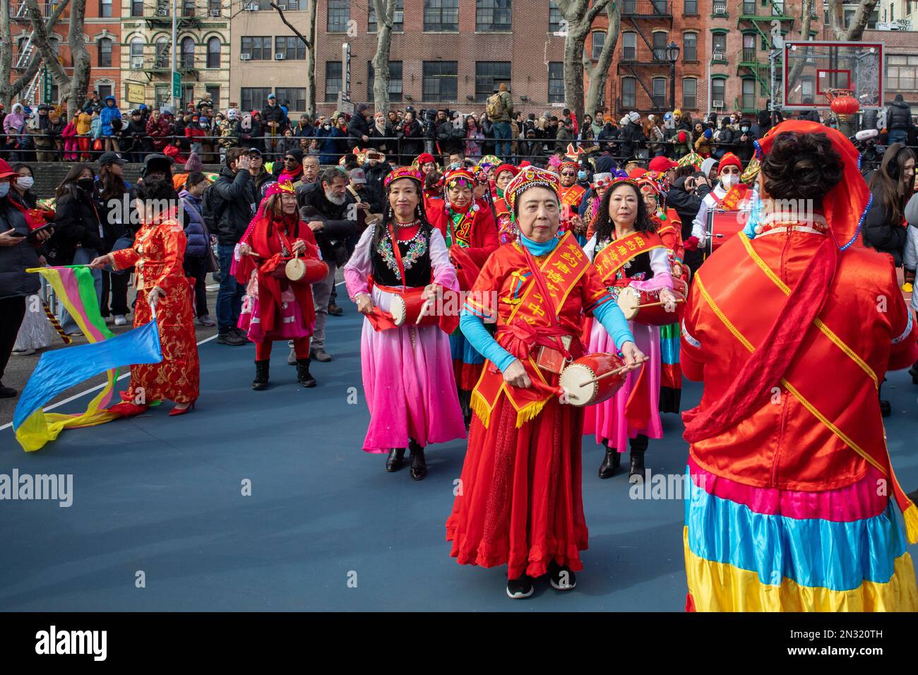 A group of people in colorful costumes in the street during the Chinese ...