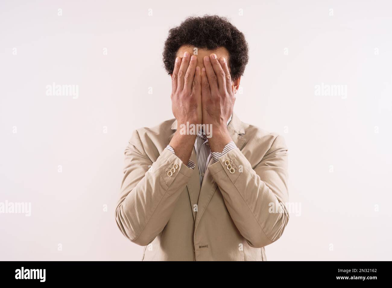 Image of desperate businessman covering his face Stock Photo - Alamy
