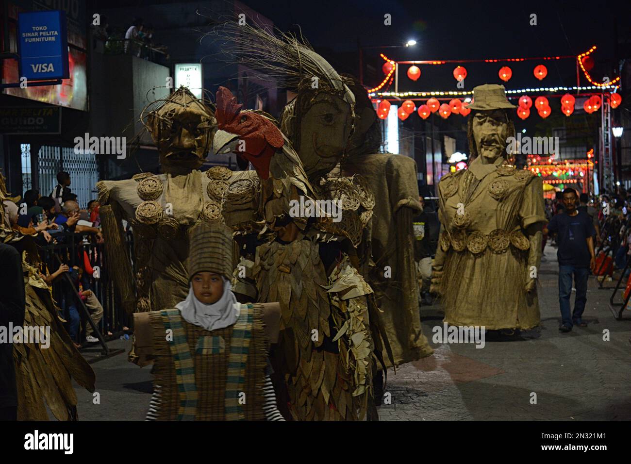 People dressing unique costume made by bamboo take part in a parade ...