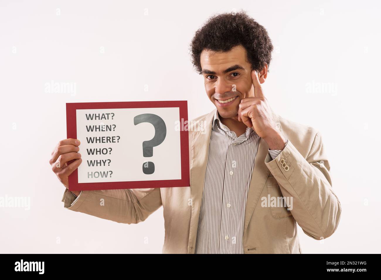Image of businessman holding paper with question mark and various ...