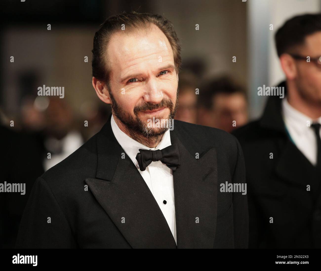 Actor Ralph Fiennes poses for photographers on arrival at the EE ...