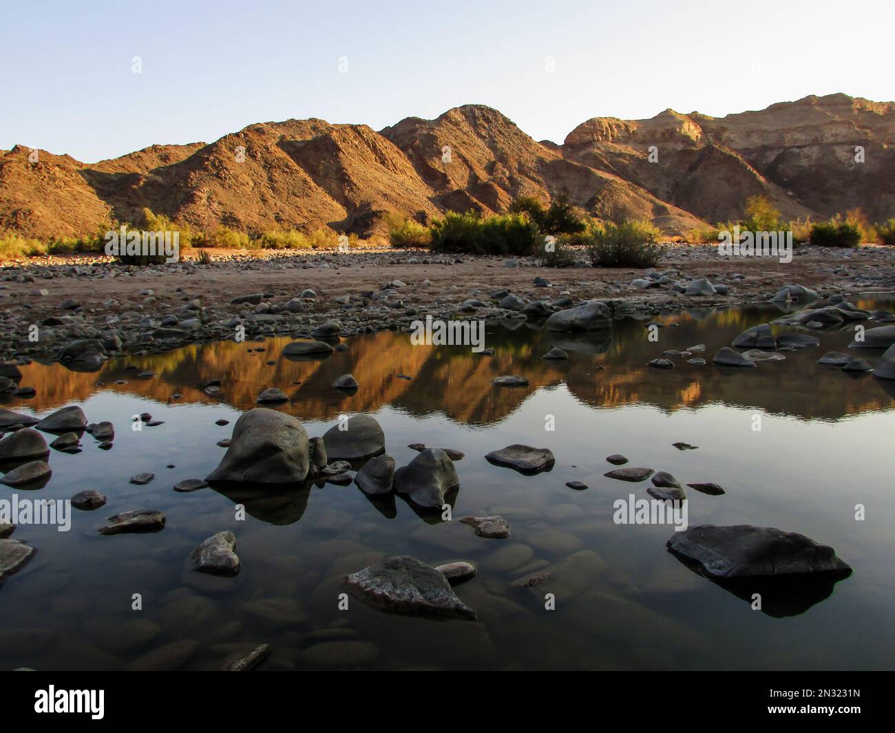 Tranquil scene of mountains reflecting into the Fish River, as seen ...