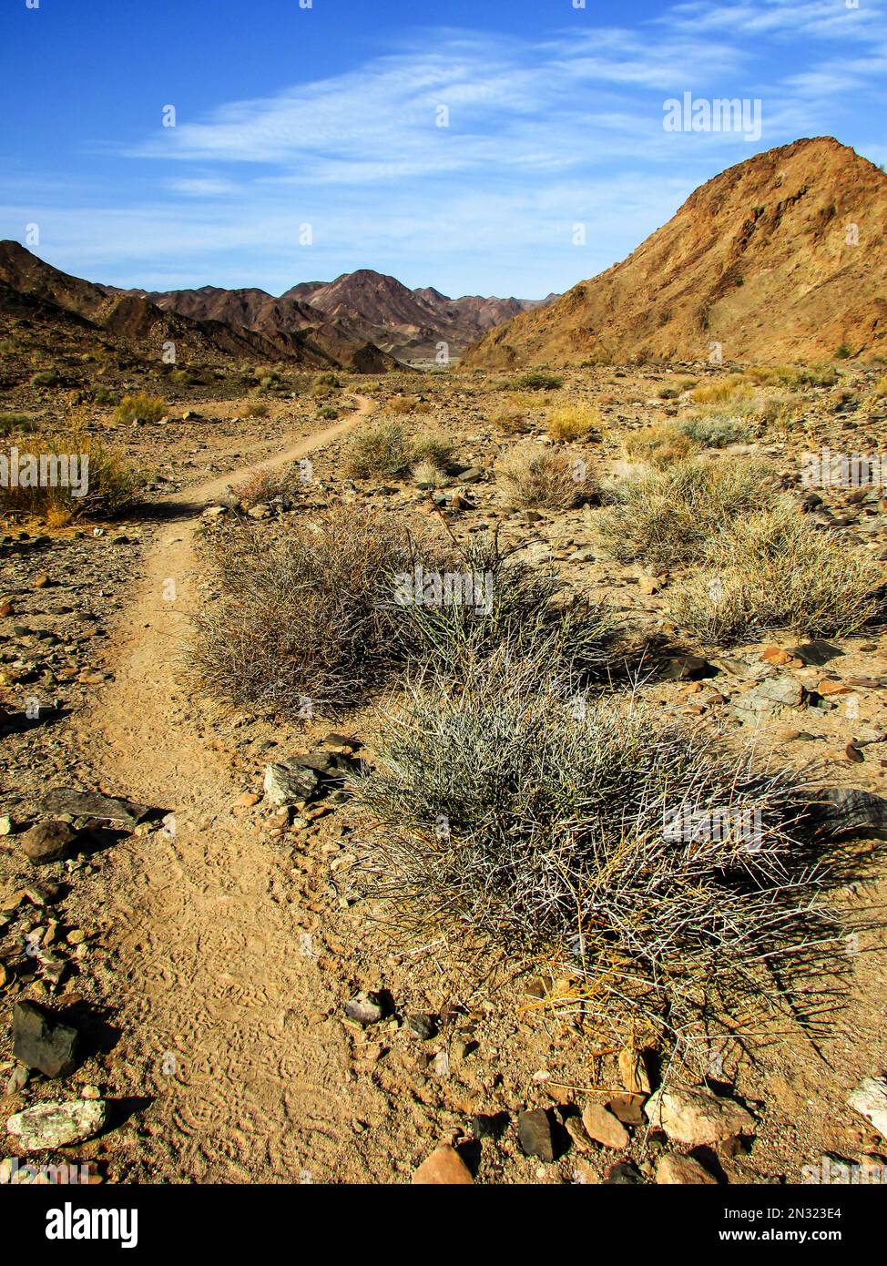 A deserted trail cutting through the dry, arid, scrubland in the Fish ...