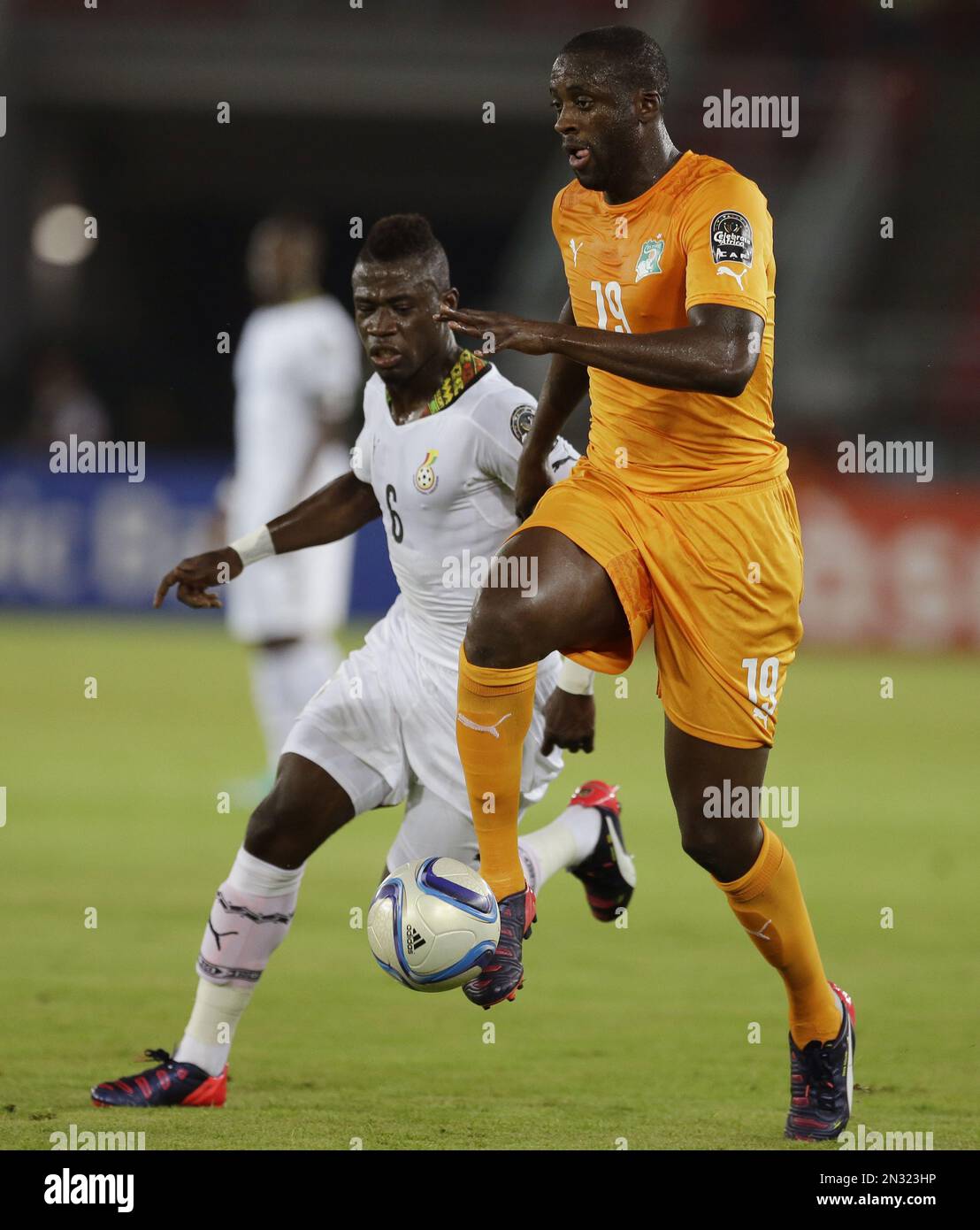 Ivory Coast's Yaya Toure, right, is challenged by Ghana's Afriyie ...