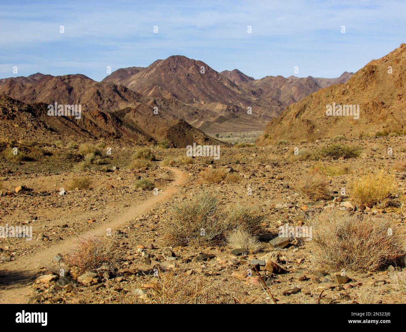 A deserted trail cutting through the dry, arid, scrubland in the Fish ...