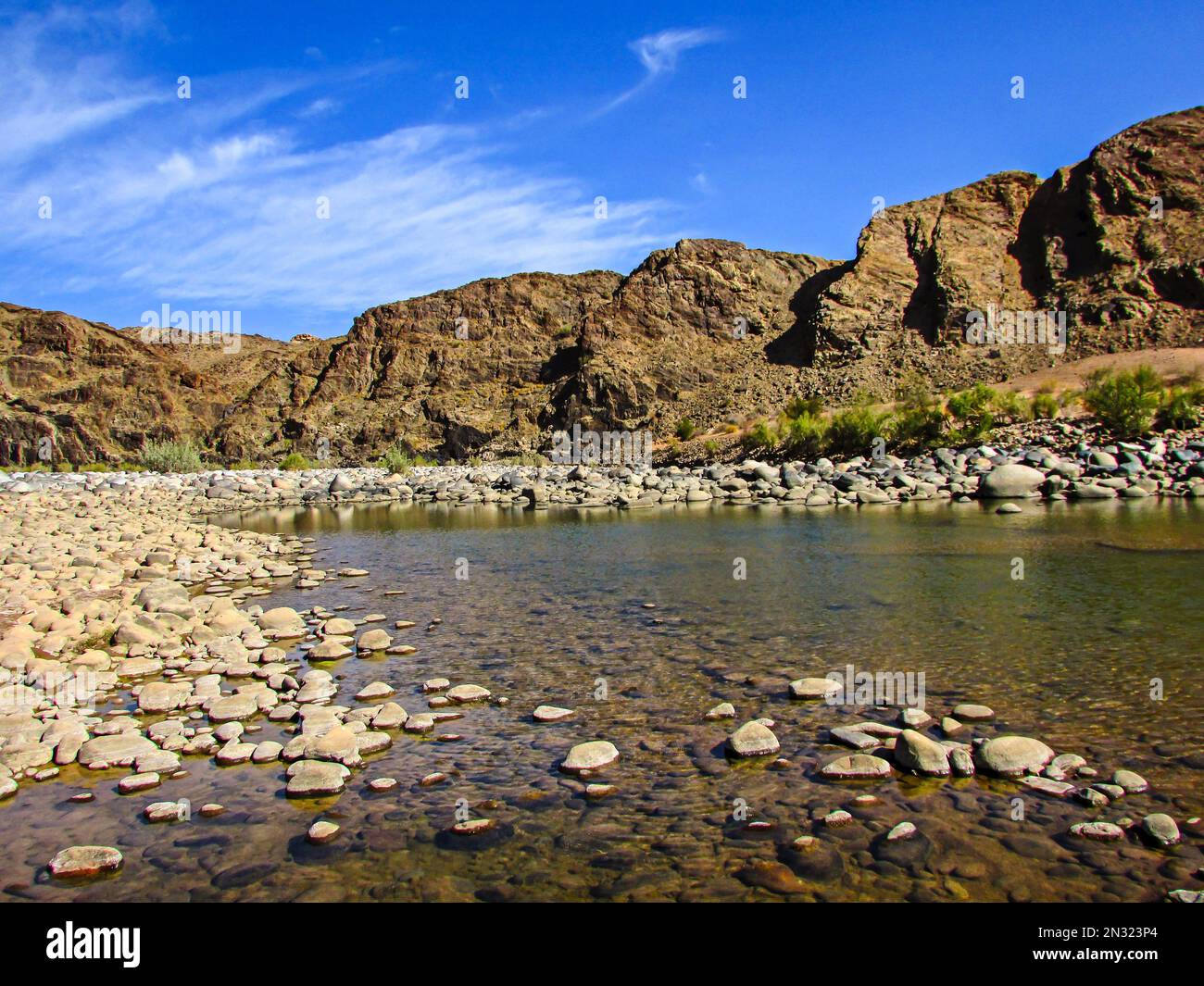 The Fish River in Namibia, with the barren rugged cliffs of the canyon ...