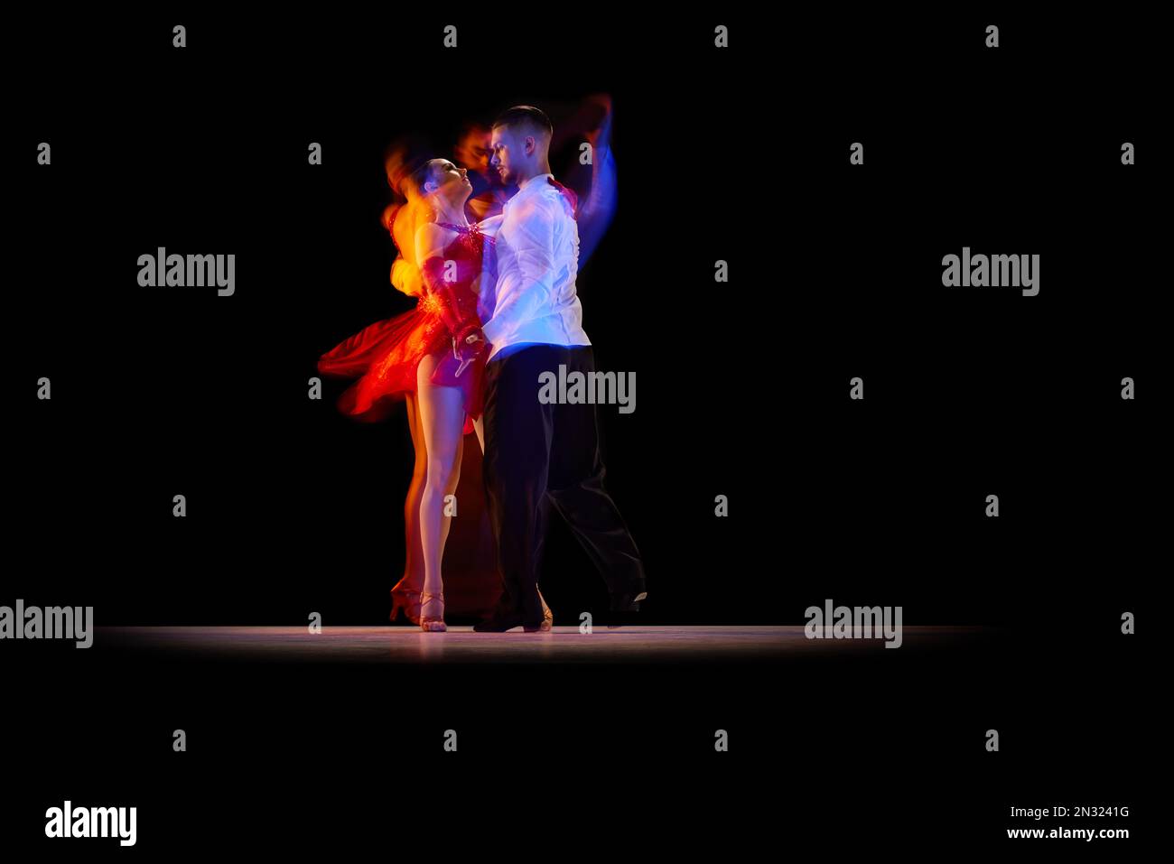 Beautiful young people, man and woman dancing tango, ballroom over ...