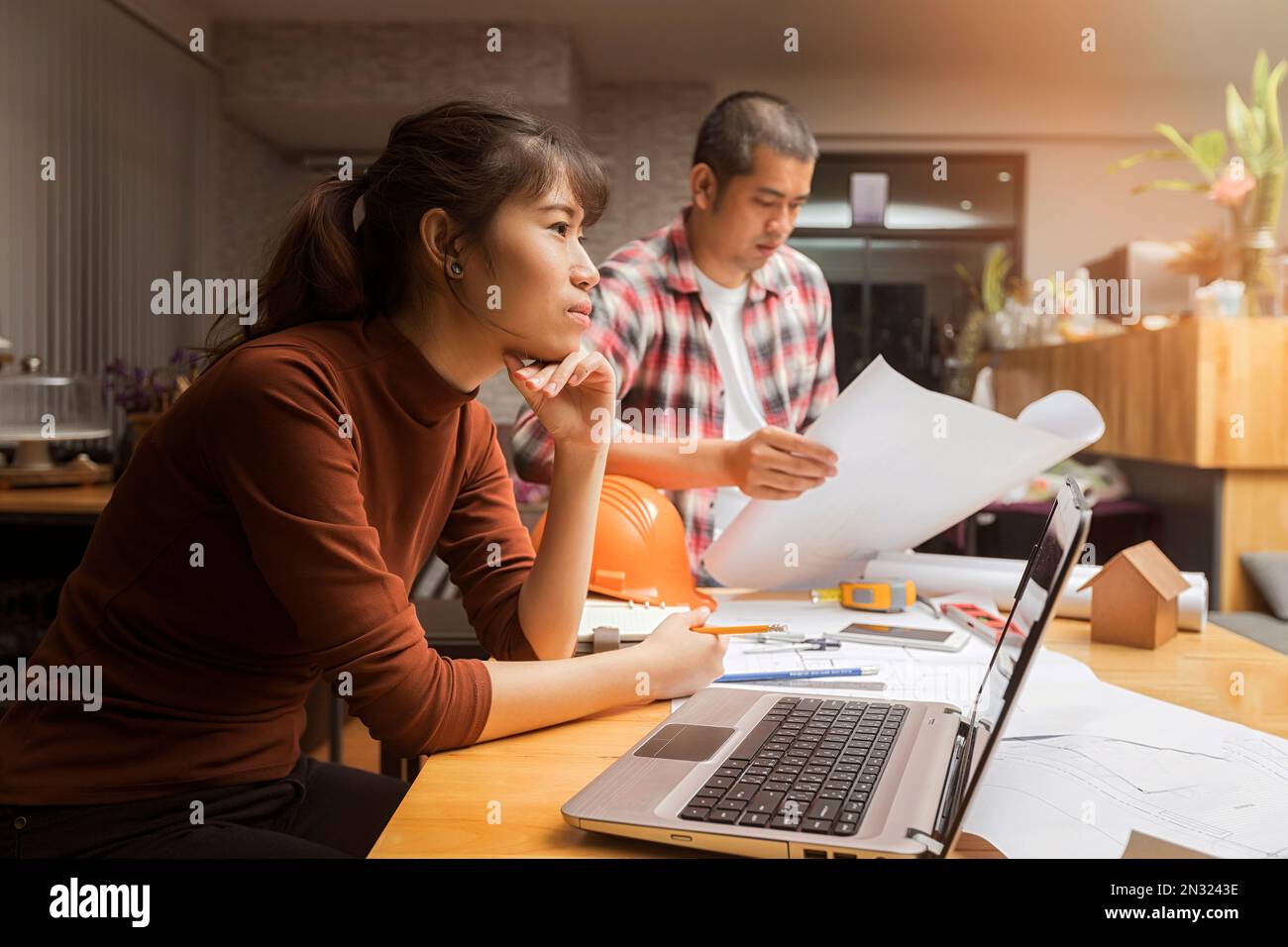 Group of two coworkers working with blueprint in office. co-working ...
