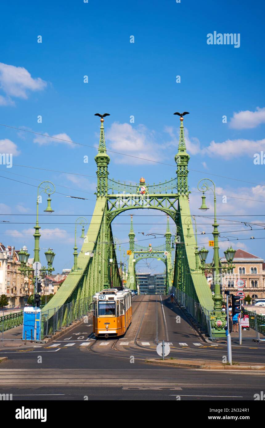 Scene at the crossroads of the embankment. A tram is traveling across ...