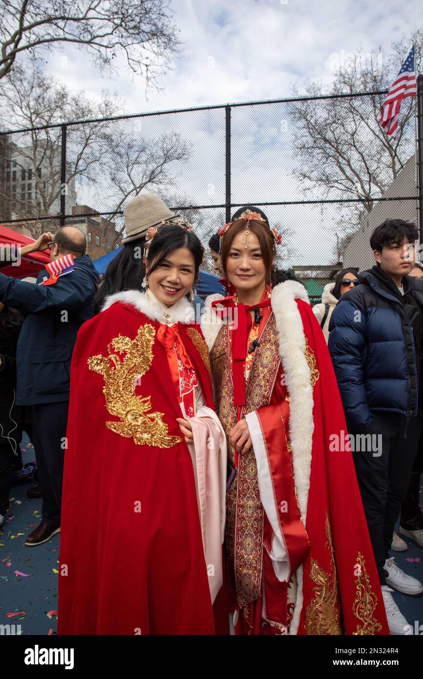 Two women in red costumes in the street during the Chinese New Year ...