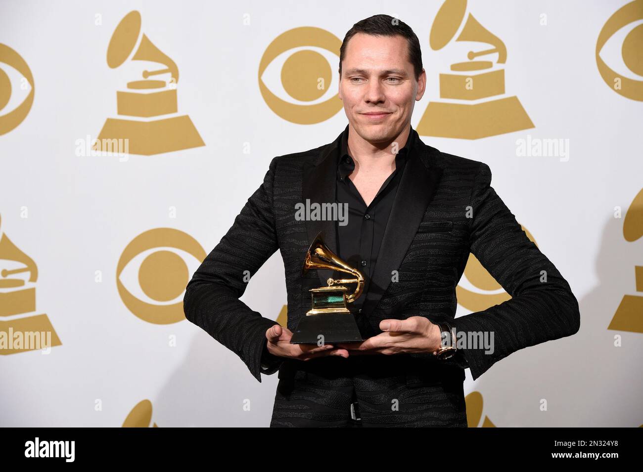 Tiesto poses in the press room with the award for best remixed ...