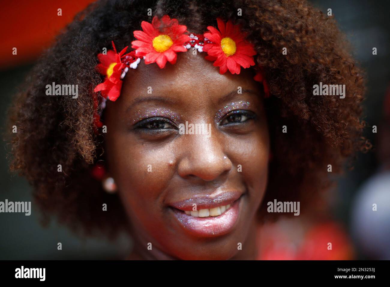 A woman poses for a photo during a street party promoting black pride ...