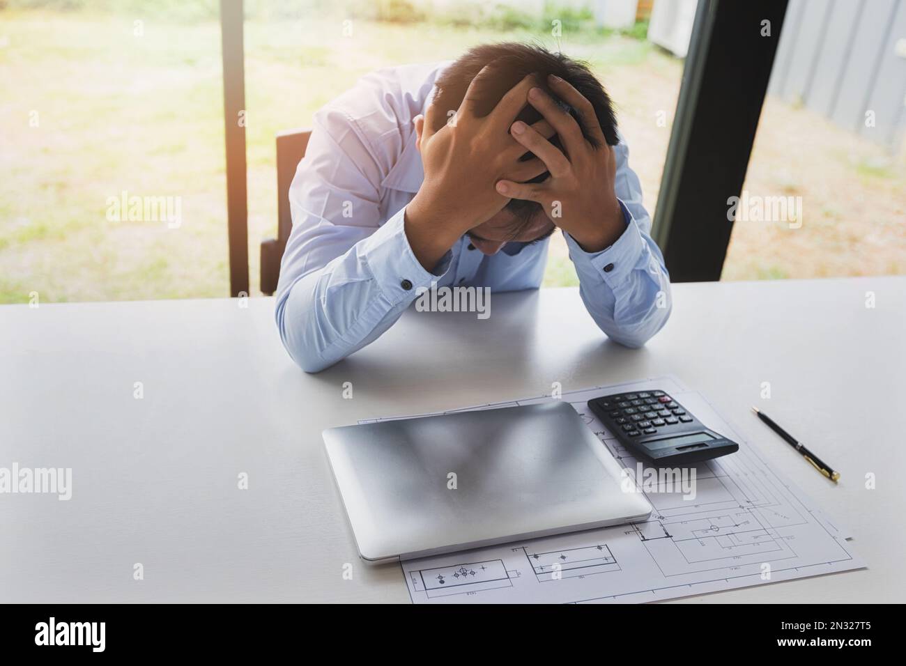 Architect in stress, tired, sad, disappointed with project problem ...