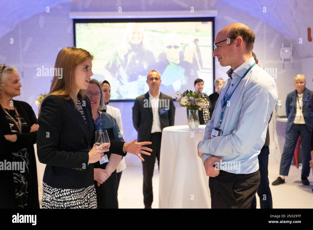 Princess Beatrice speaks to researchers during a visit to the the ...