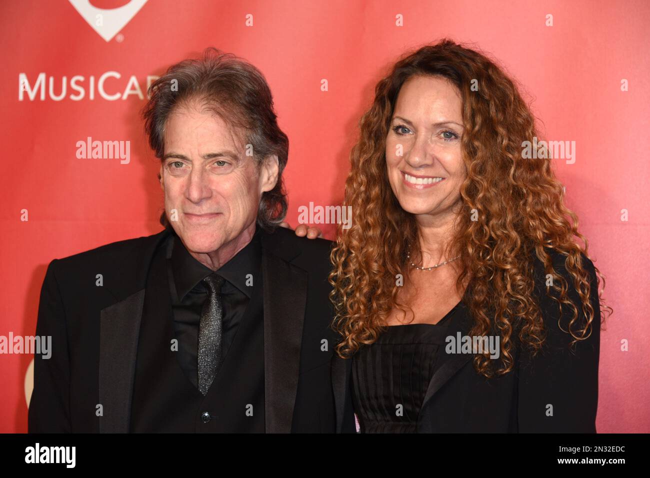 Richard Lewis, left, and Joyce Lapinsky arrive at the 2015 MusiCares ...