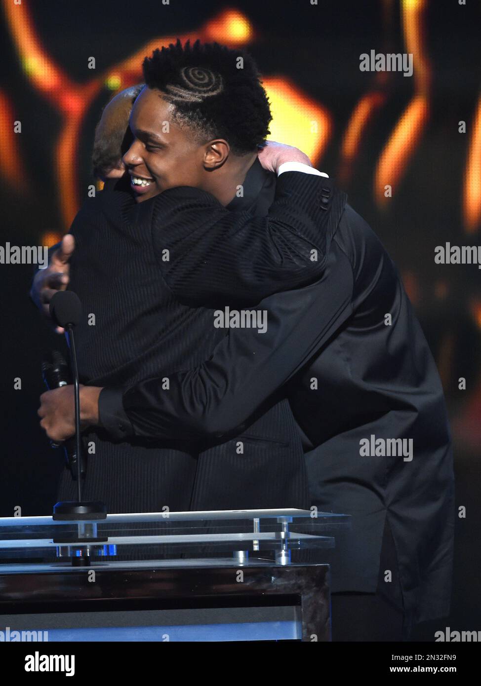 Clive Davis, left, and Avery Wilson hug on stageat the 46th NAACP Image ...