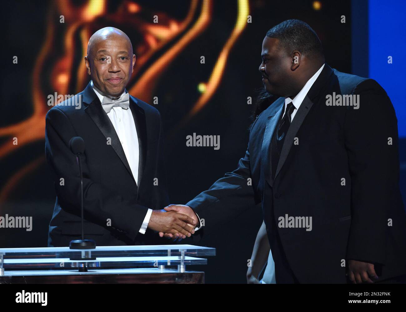 Russell Simmons, left, and John Gaskin III present the Vanguard Award ...