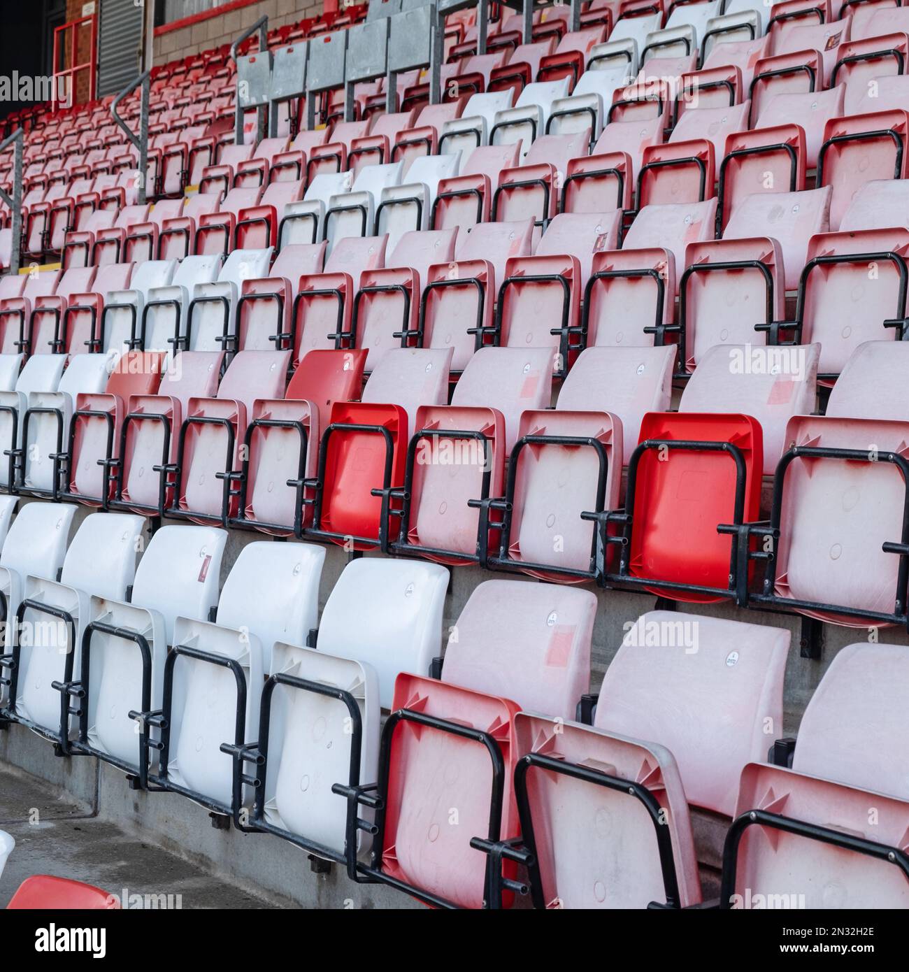 Patterns formed by a section of seating in an English sports stadium ...