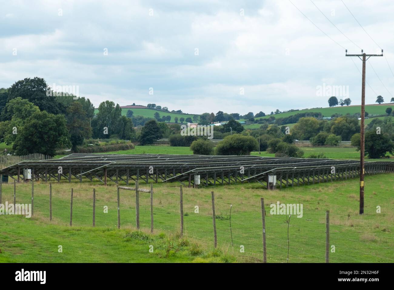 Rear view of arrays of solar panels installed on a farm in East Devon ...