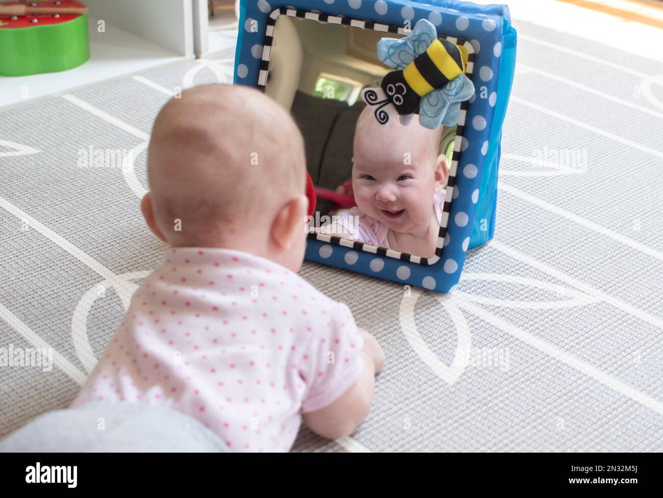 baby-looking-in-the-mirror-during-tummy-time-stock-photo-alamy