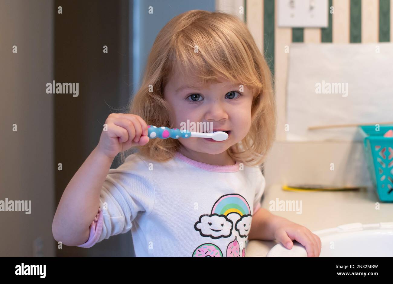 Toddler girl brushing teeth with toothbrush Stock Photo - Alamy