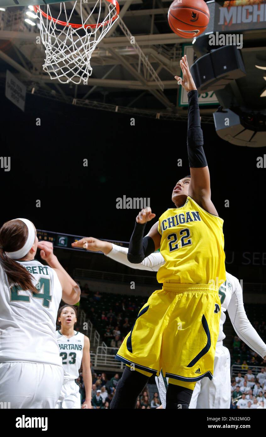 Michigan's Cyesha Goree (22) shoots over Michigan State's Lexi Gussert ...