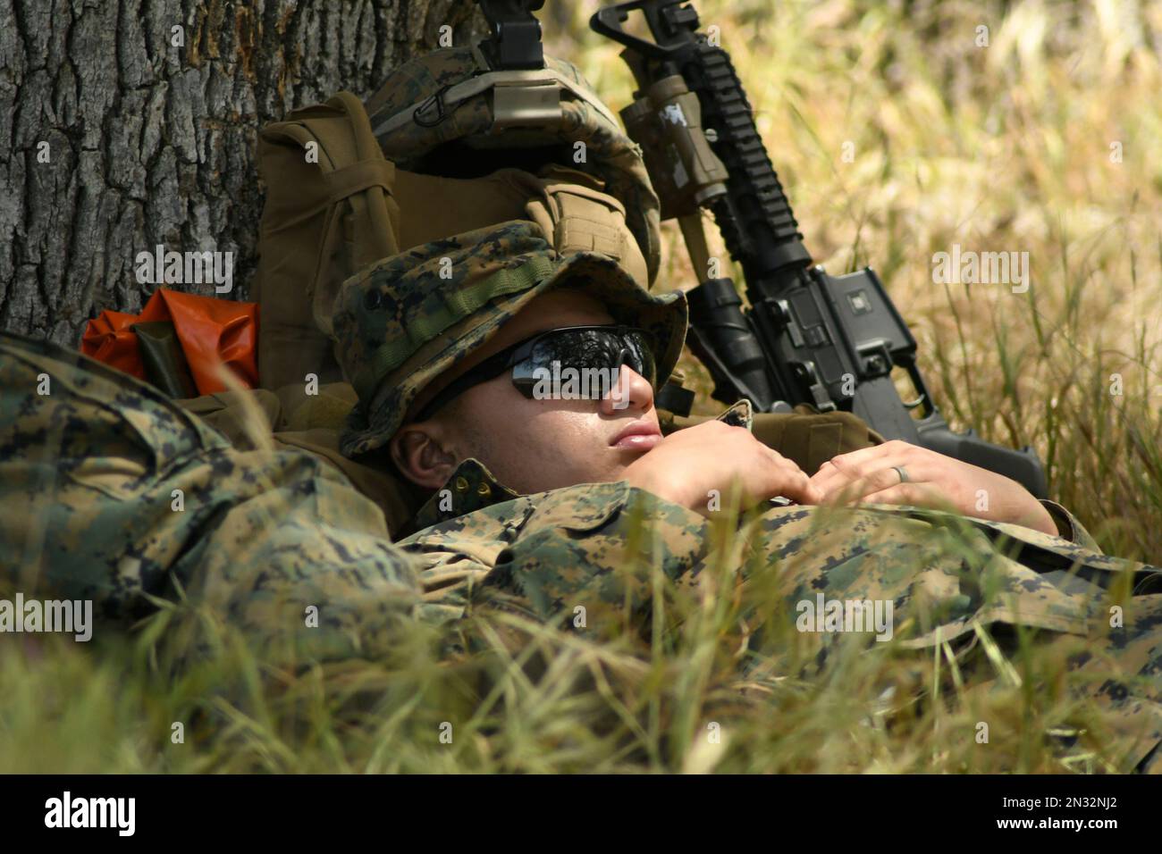 Marine with rifle in 13th Marine Expeditionary Unit, takes a break ...